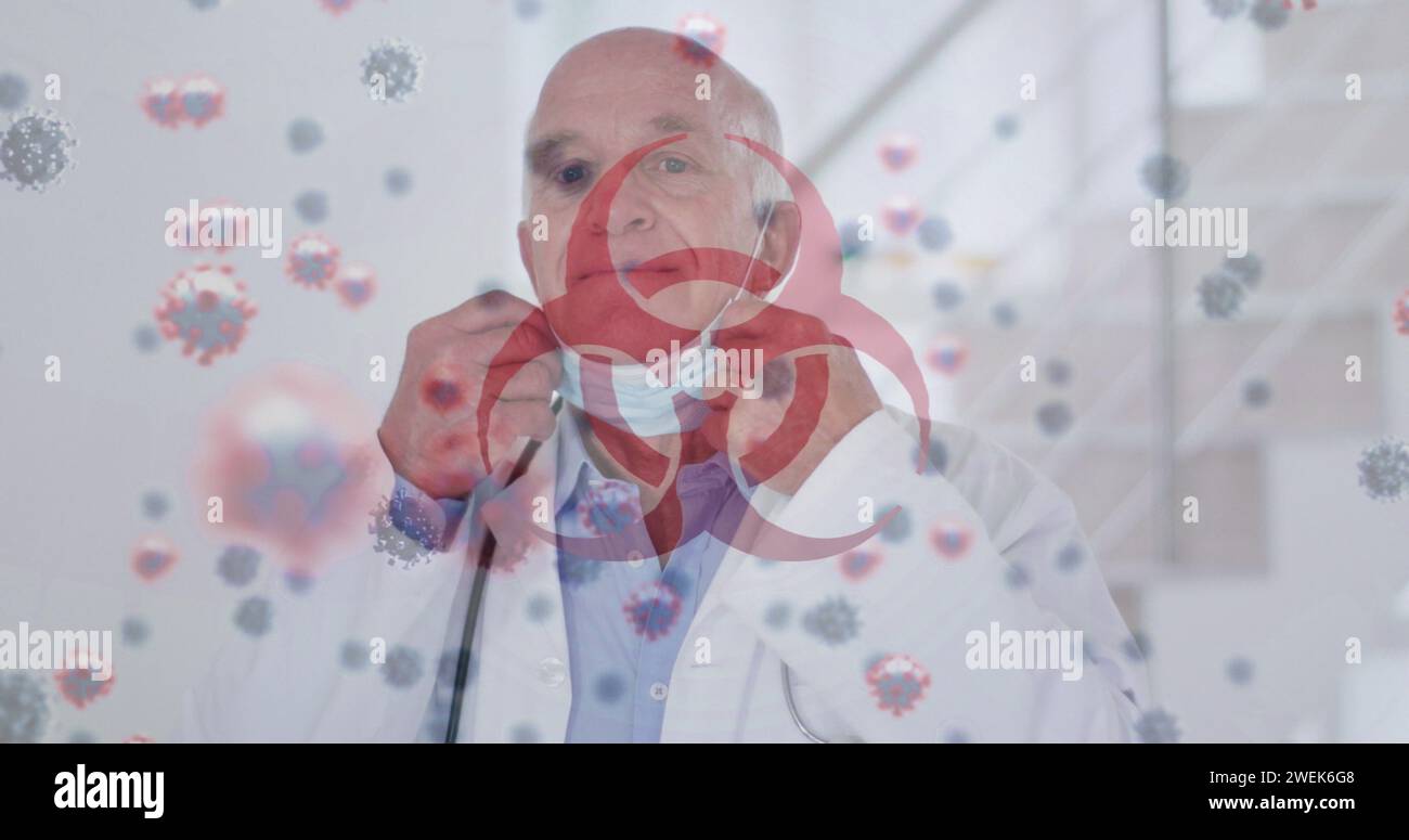 Biohazard symbol and covid-19 cells floating against male senior doctor ...