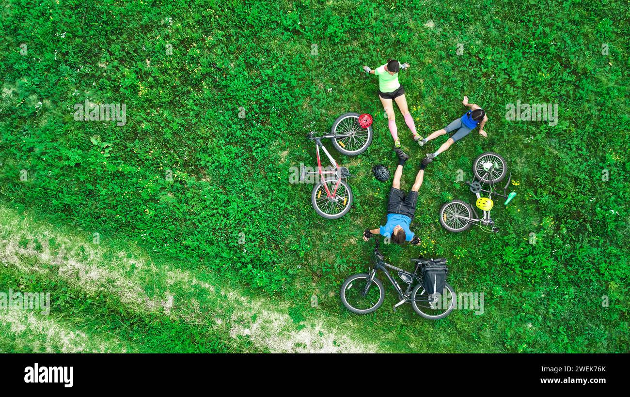 Family cycling on bikes aerial drone view from above, happy active ...