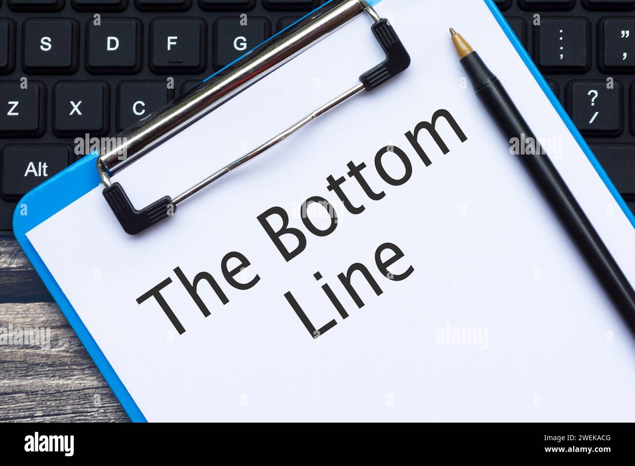 Clipboard with the bottom line text with pen and keyboard on wooden ...