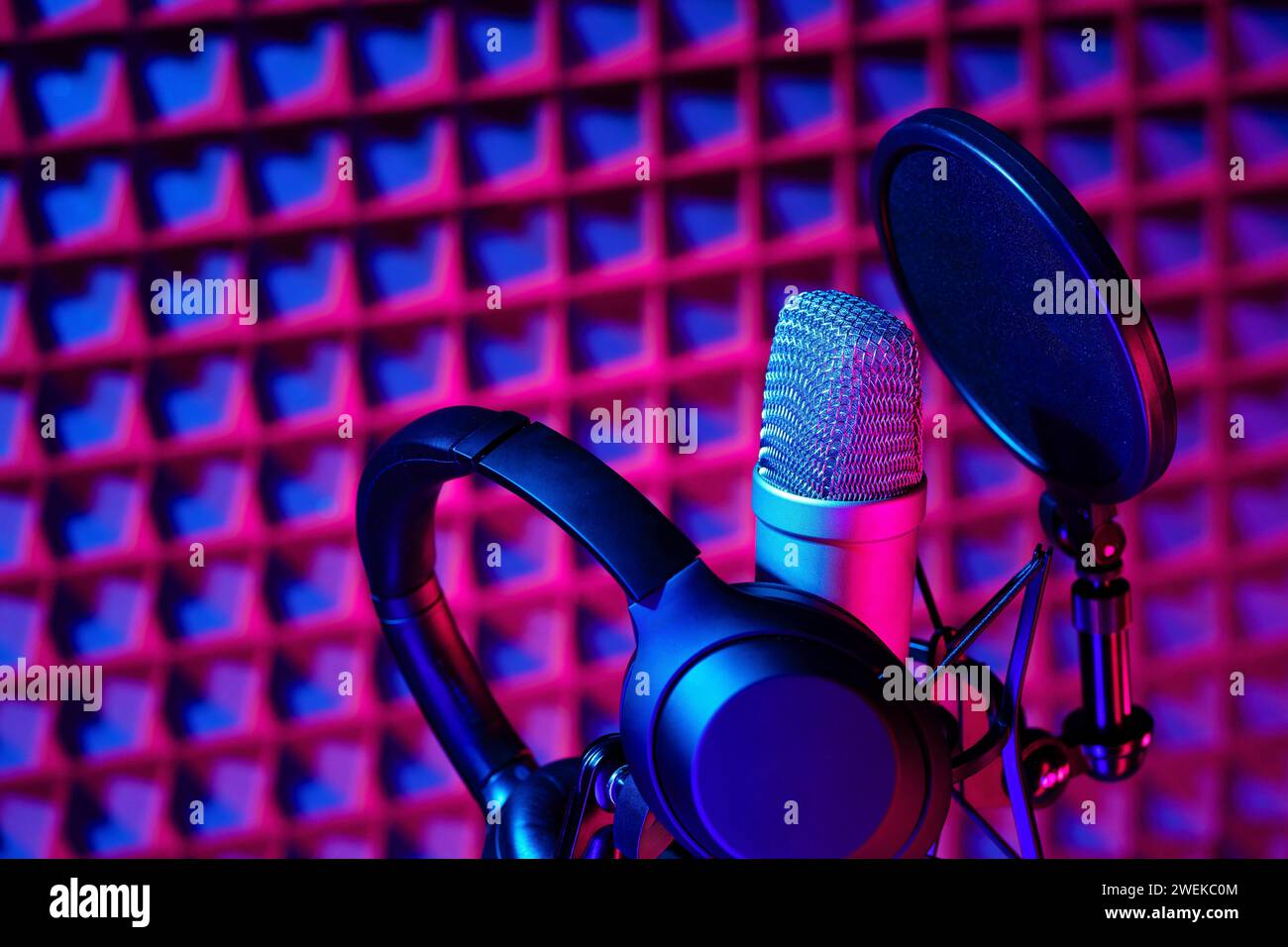Professional studio microphone against acoustic foam panel background ...