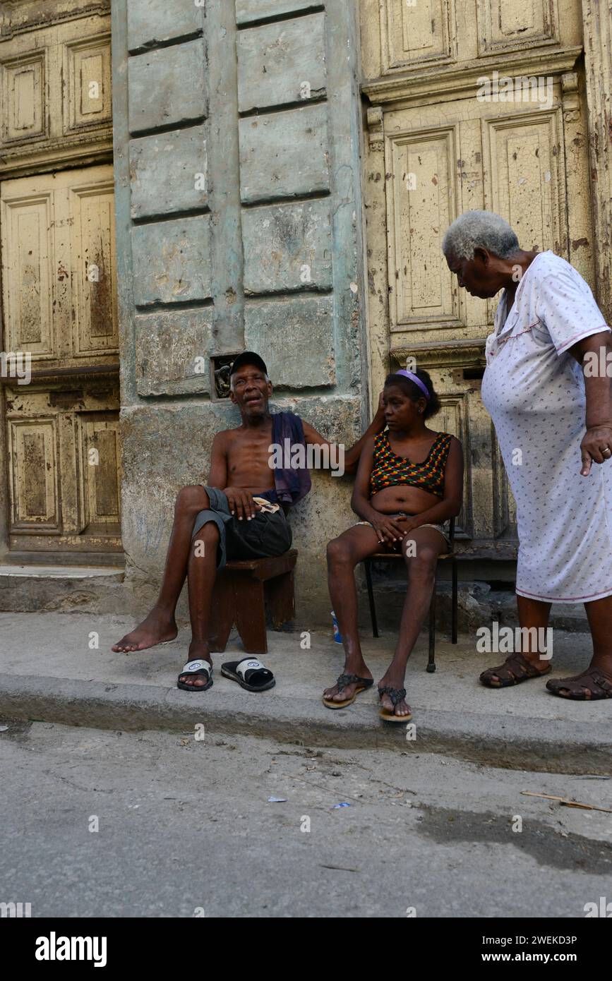 Locals sitting outside their homes in old Havana, Cuba Stock Photo - Alamy