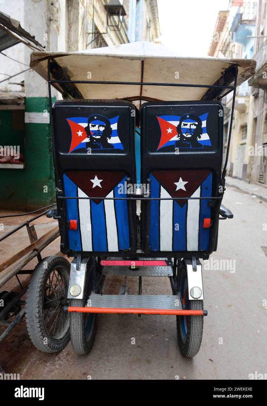 A bicitaxi decorated with paintings of the Cuban flag with Che Guevara ...