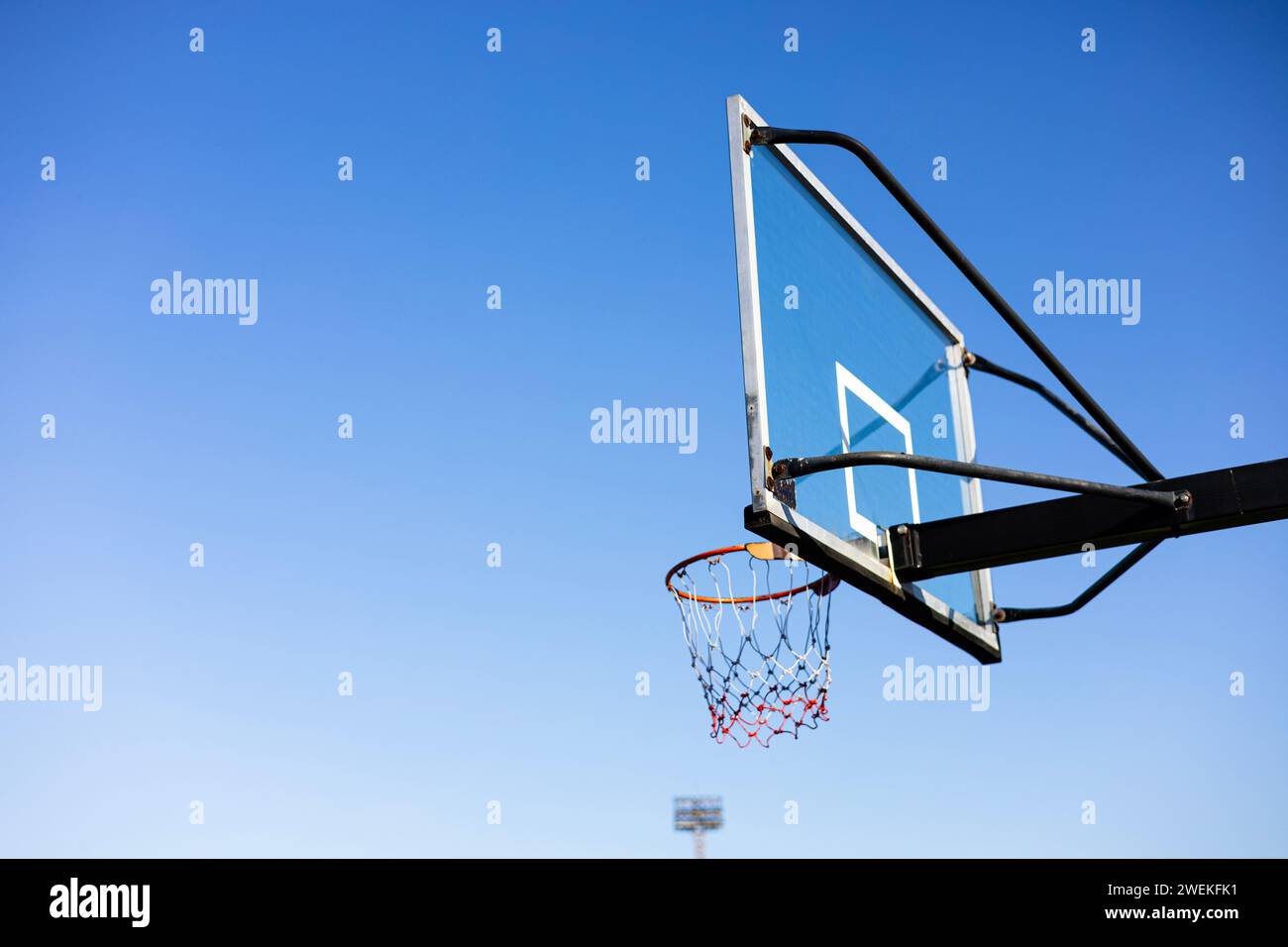 Outdoor Basketball hoop with blue sky background in the public arena ...