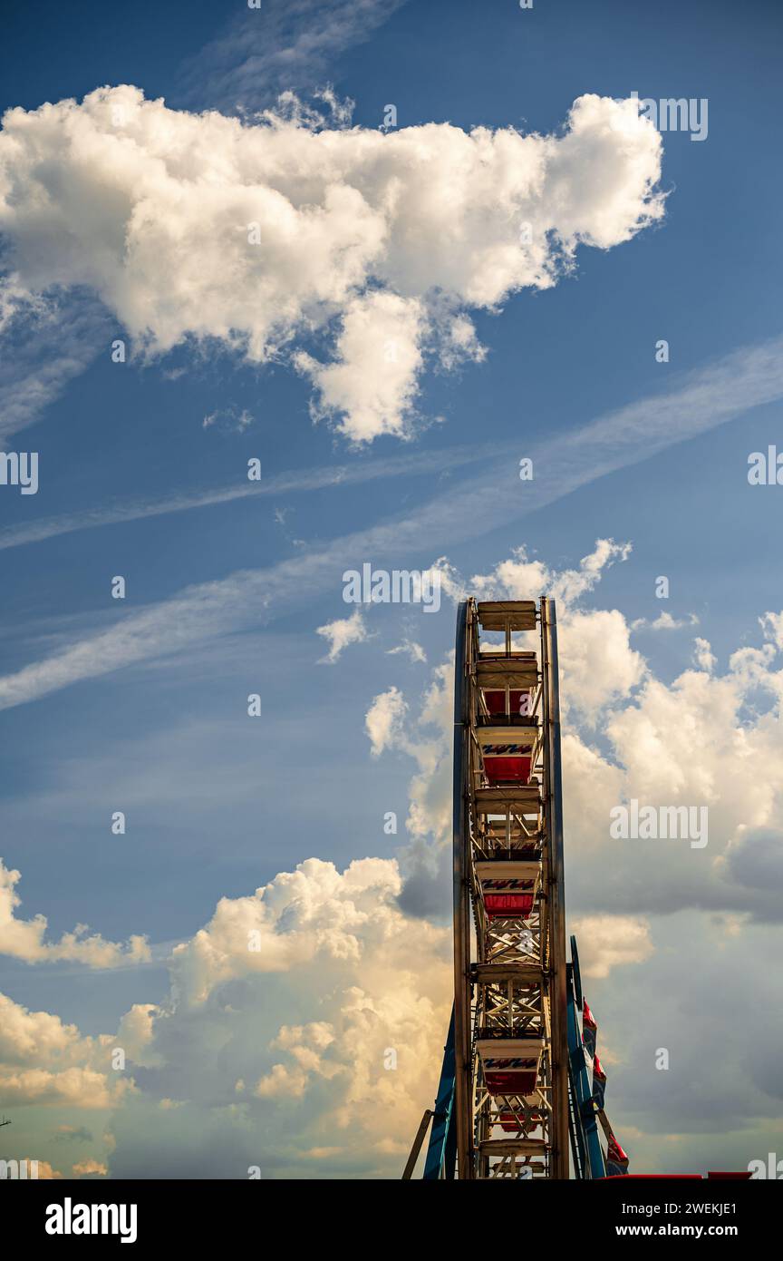 Photo capturing the top of a Ferris wheel reaching towards a tranquil ...