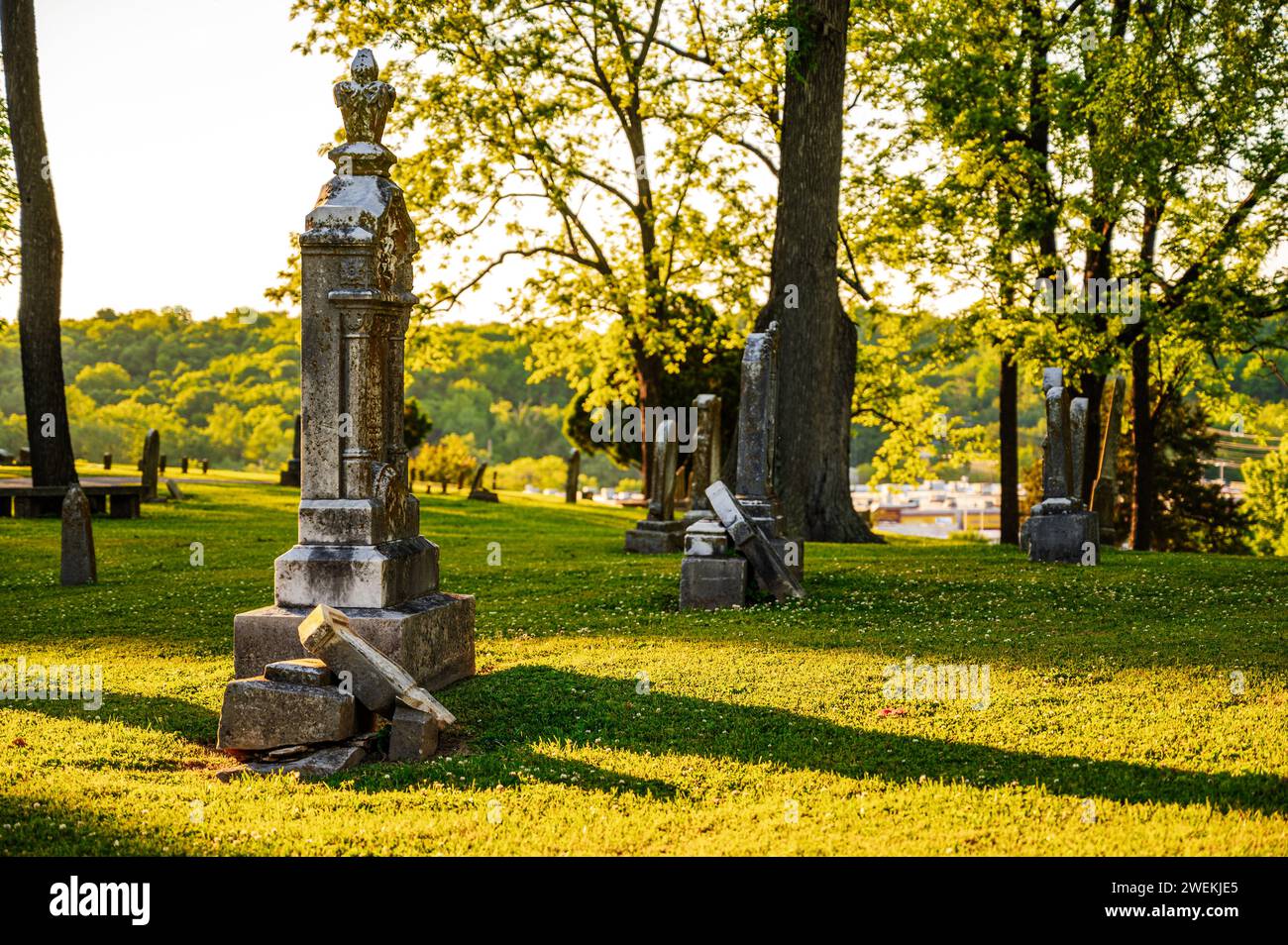 Golden Hour Illumination Over Cemetery Monuments and Serene Landscape Stock Photo - Alamy
