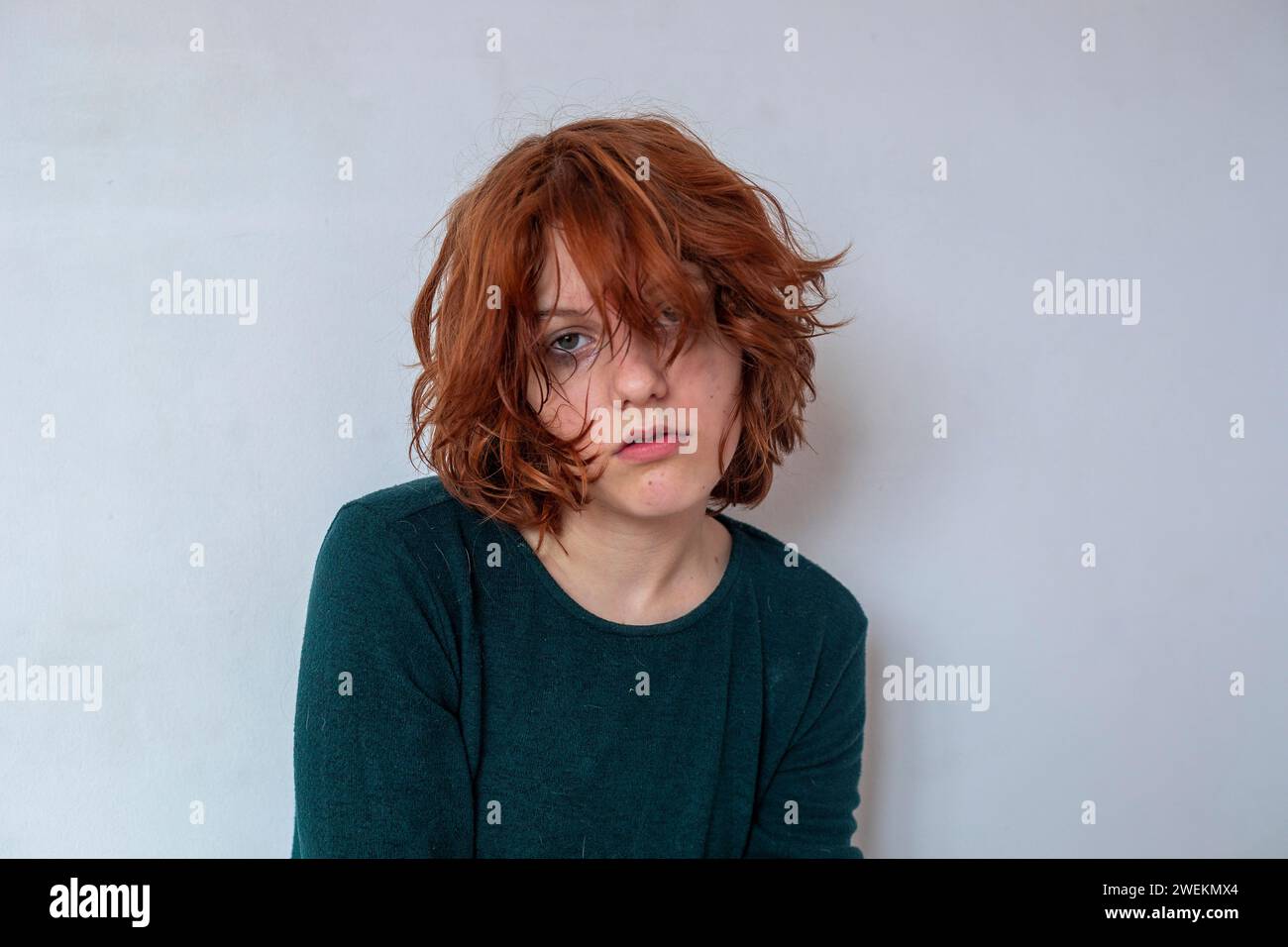 teenage girl with red hair is crying in her room. Emotion management ...