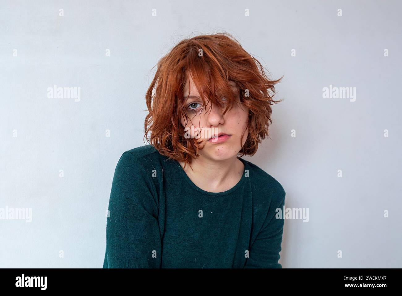 teenage girl with red hair is crying in her room. Emotion management ...