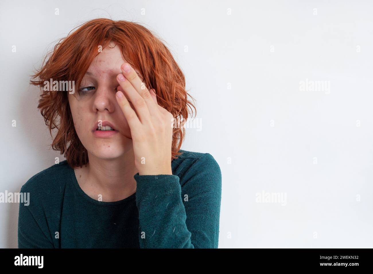 upset teenage girl with red hair is crying in her room. Emotion ...