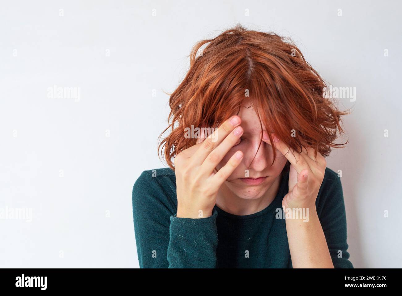 girl with red hair is crying in her room. Emotion management Stock ...