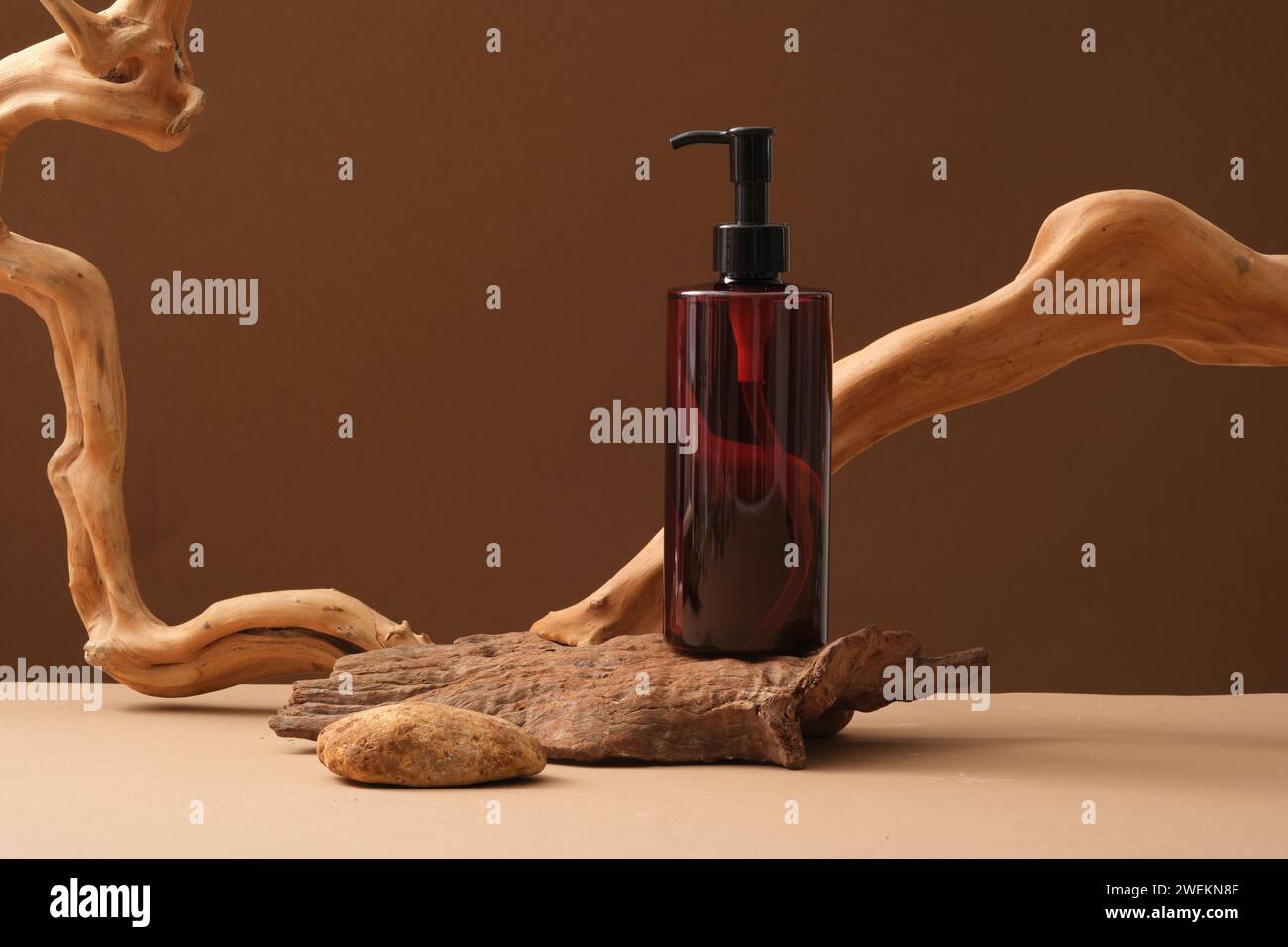 Scene with amber bottle without label and dried twigs decorated on ...