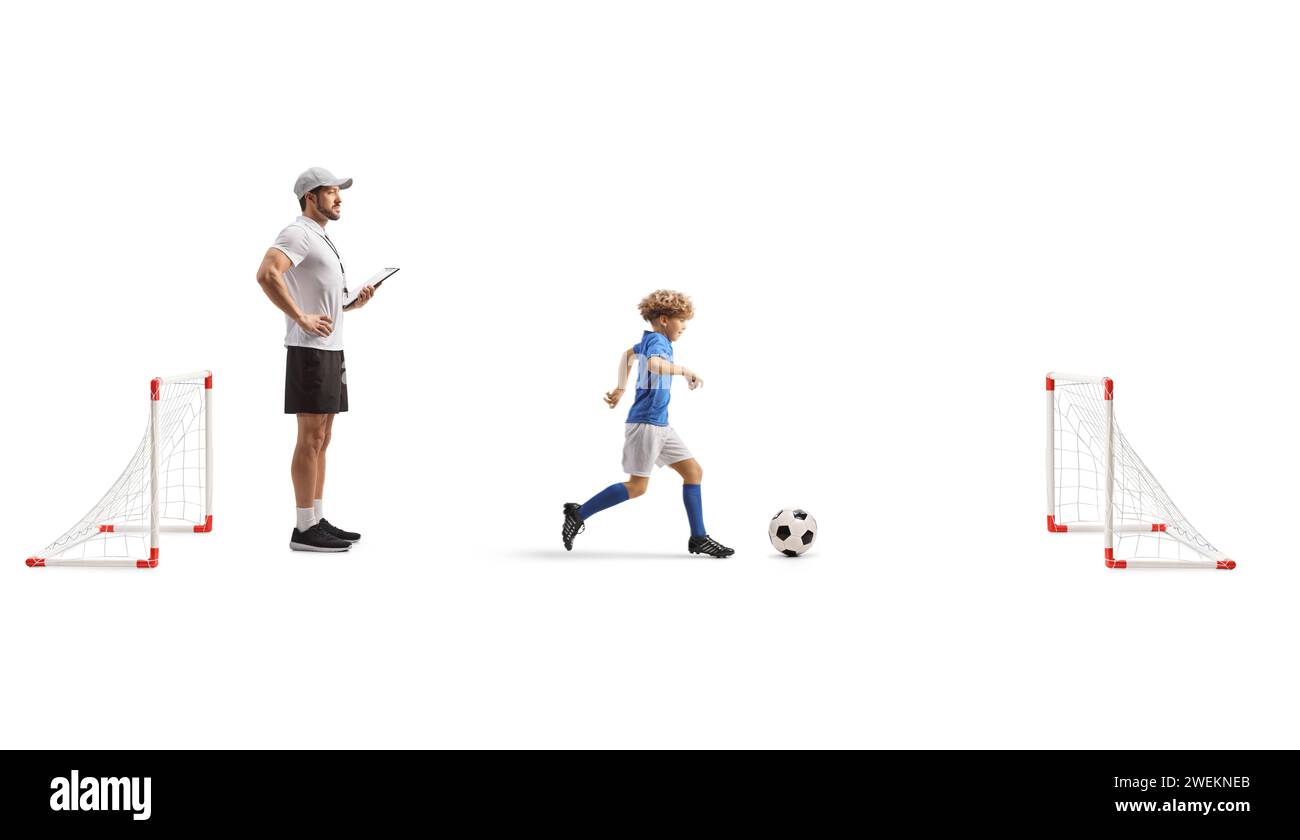 Coach watching a boy at training football between two goals isolated on ...