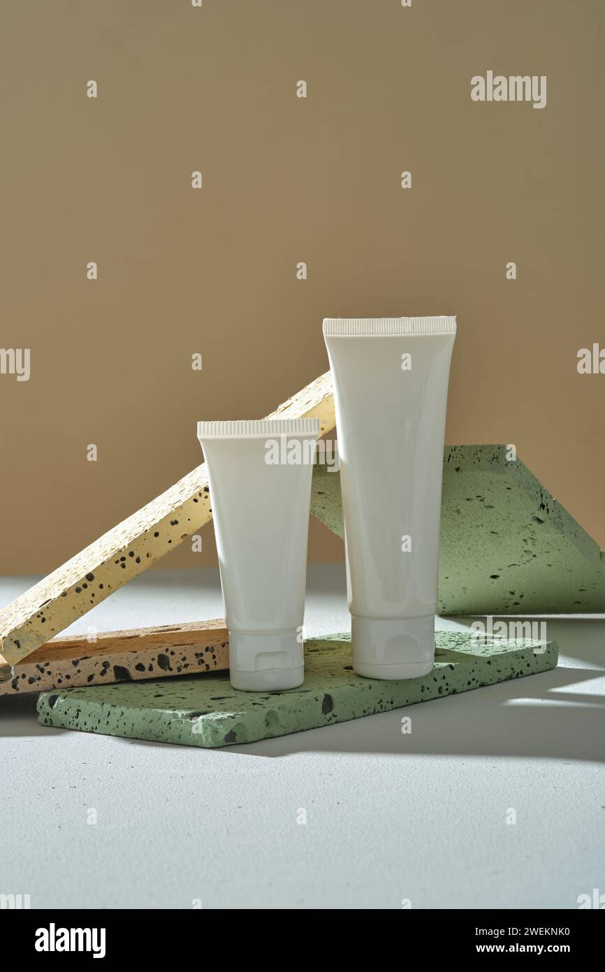 Front view of two white plastic bottle unlabeled and colorful rectangle ...