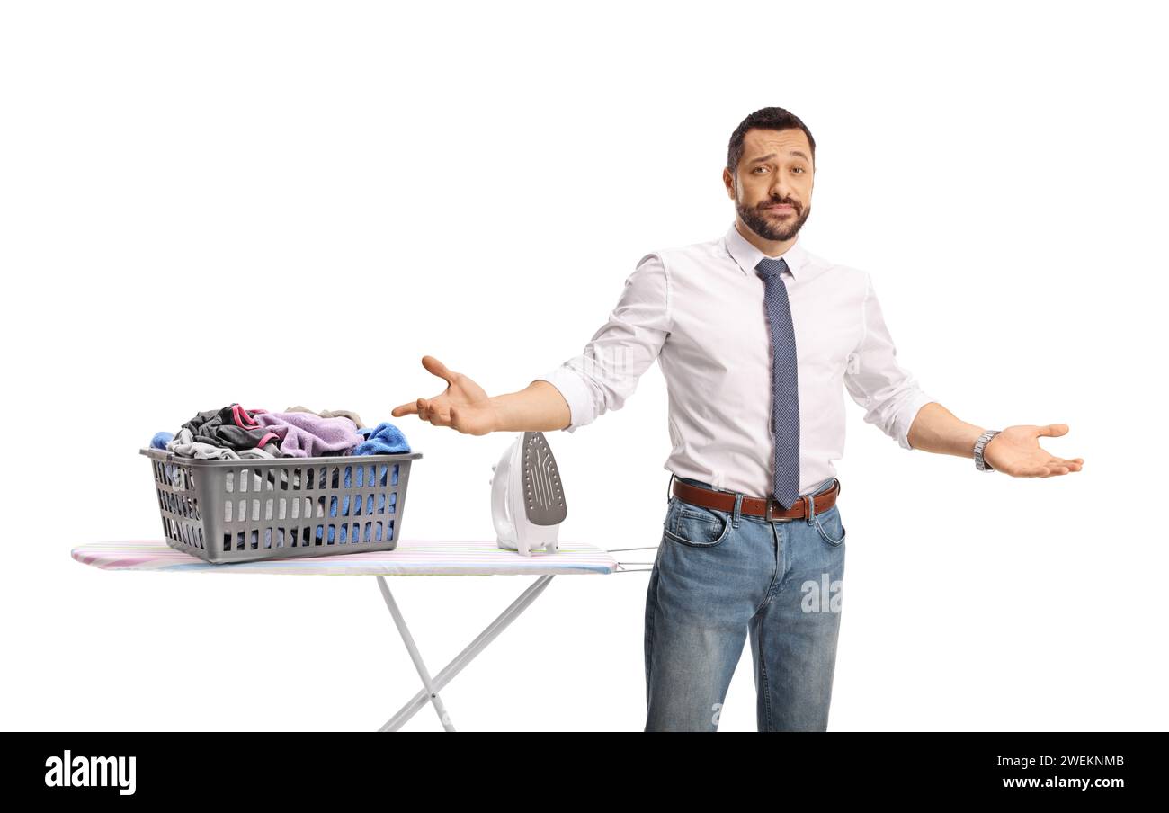 Bored businessman standing in front of clothes and iron board isolated ...