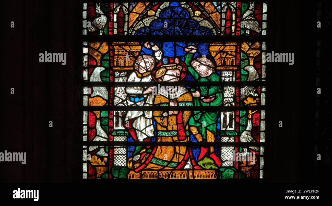 Medieval stained glass window, of an attack on a holy priest, in the ...