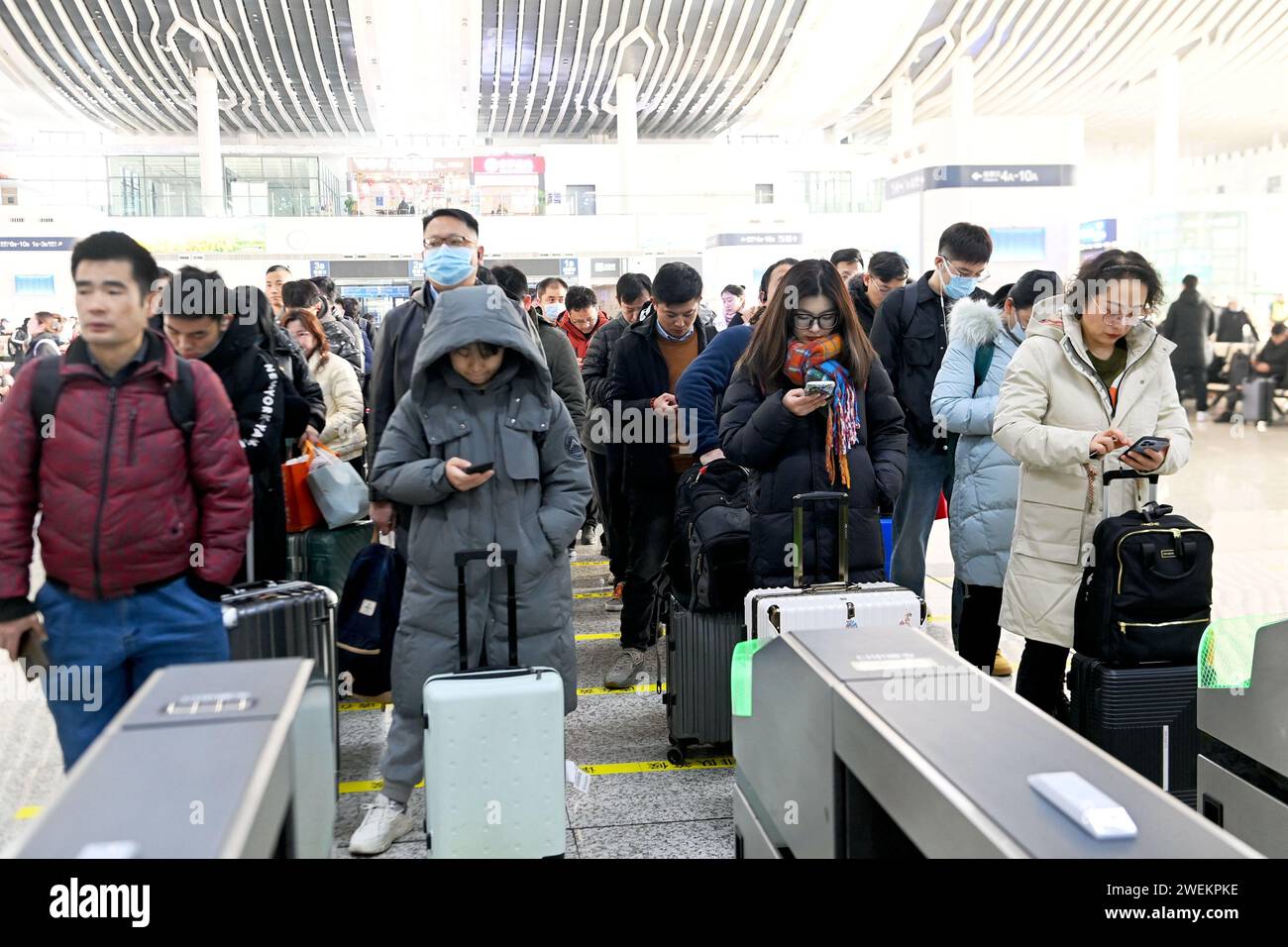 Passengers queue to check in at Qingdao West Railway Station in East ...