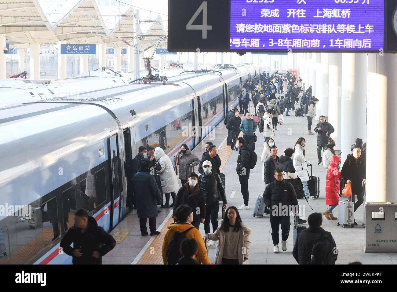 Passengers walk to the boarding point at Qingdao West Railway Station ...