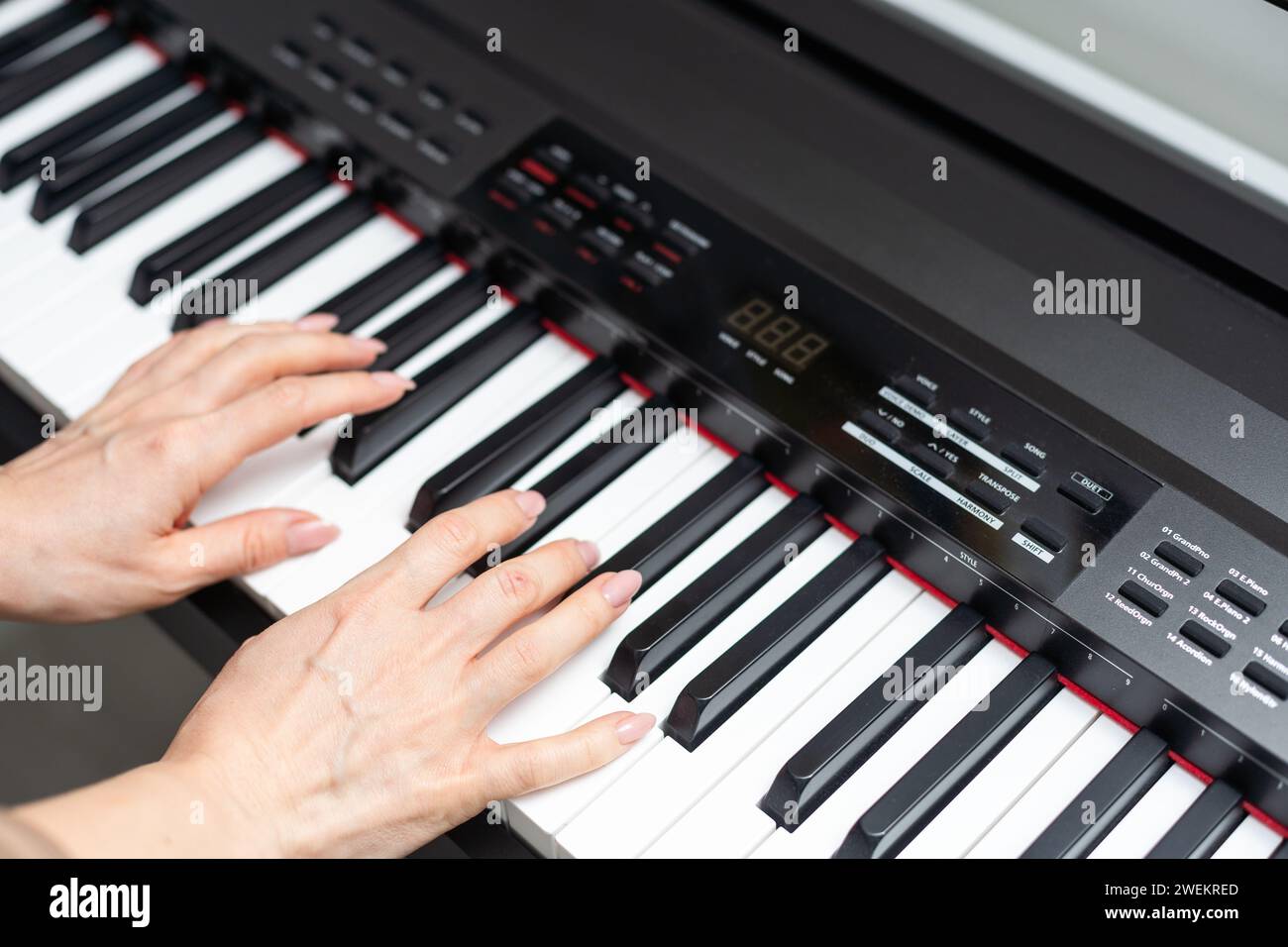 keyboard and hands playing the piano Stock Photo - Alamy