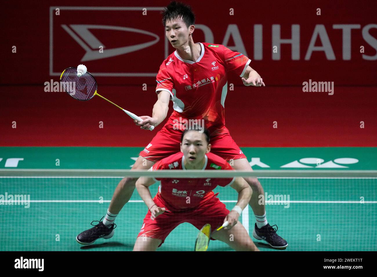 China's Wei Ya Xin, front, and Jiang Zhen Bang play a shot to Japan's Natsu Saito and Hiroki ...