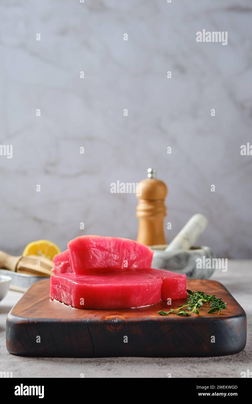 Low angle view of raw ahi tuna steak on cutting board with spice Stock ...