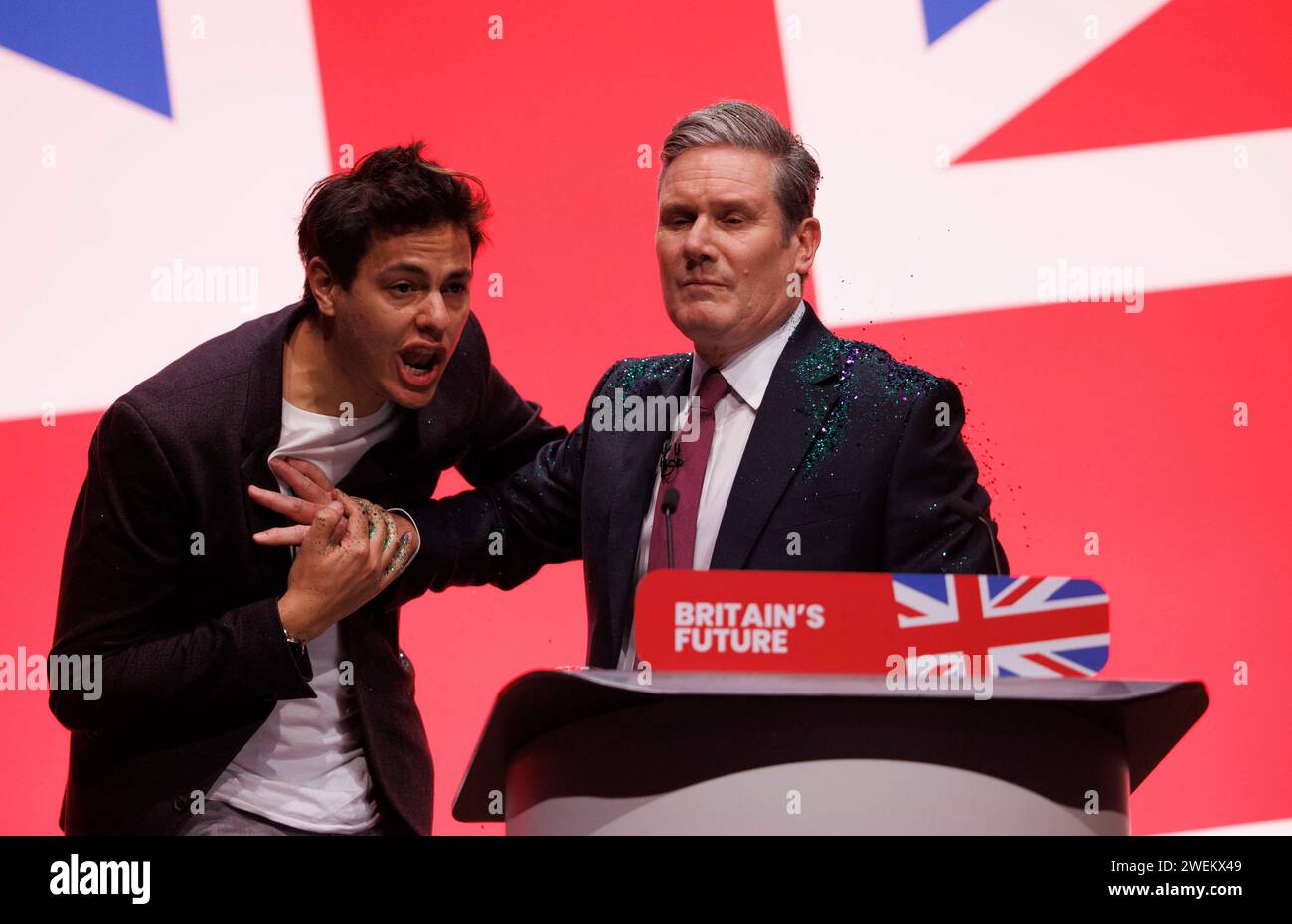 Yaz Ashmawi pours glitter on Sir Keir Starmer at the beginning of the ...