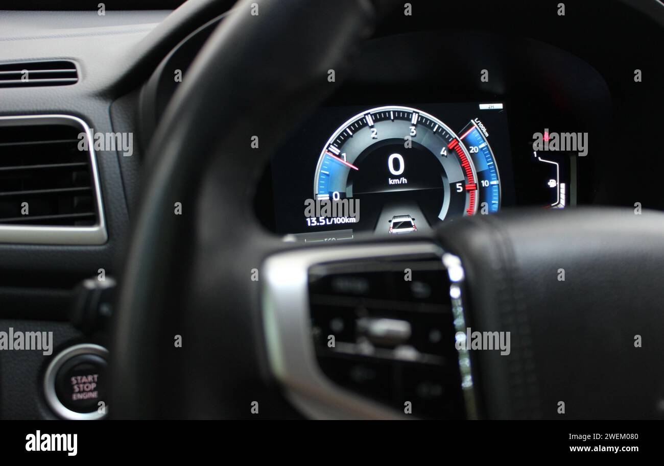 Digital tachometer with colored backlight on the central panel of a ...