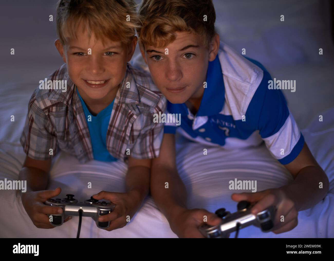 Video game children playing with video games in their bedroom hi-res ...