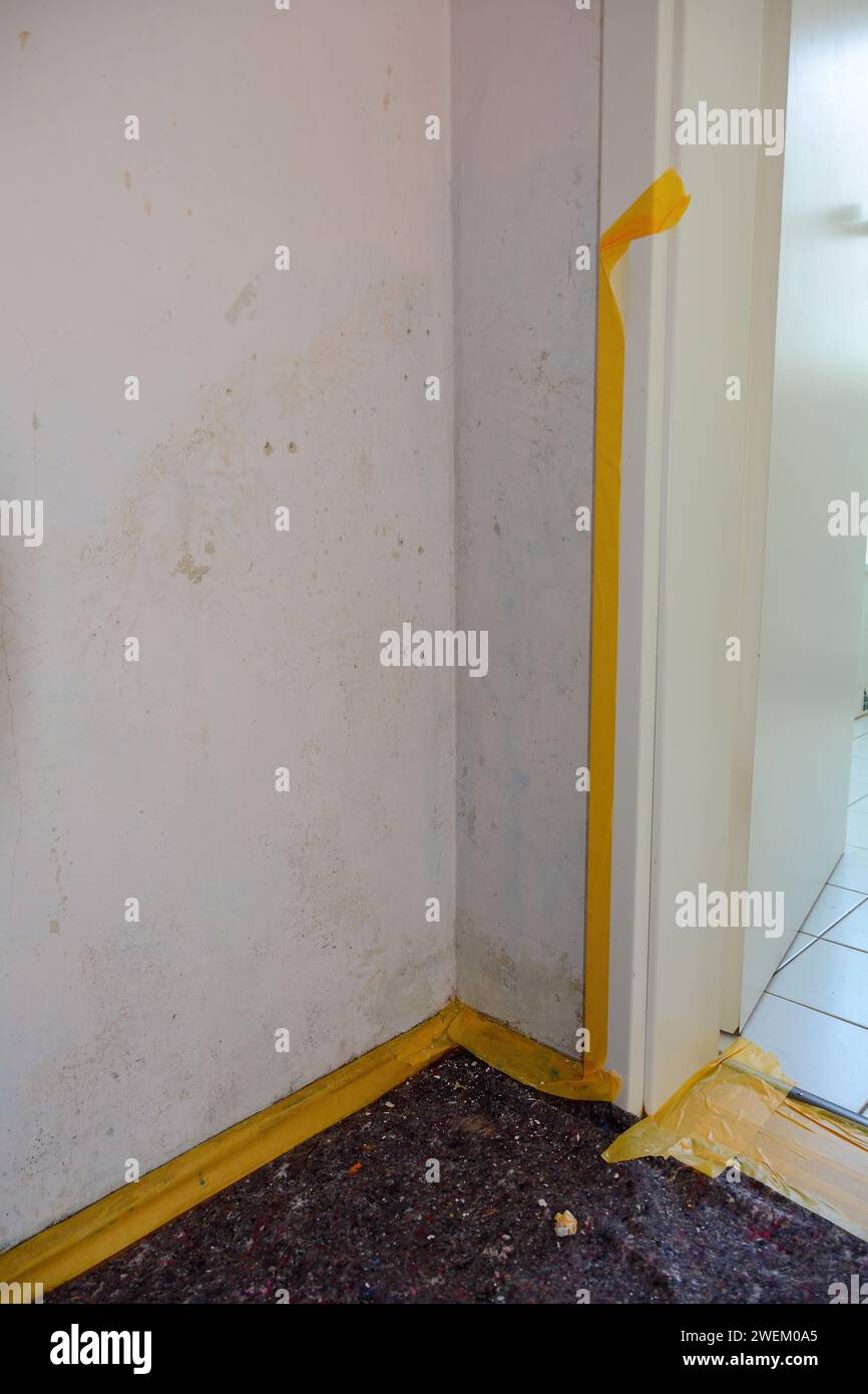 A room in an apartment during renovation with the floor taped off to ...