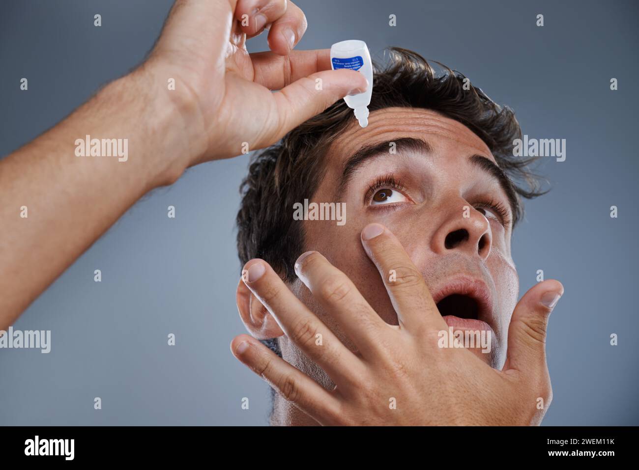Man, eye drops and vision for allergies care in studio or healthcare ...