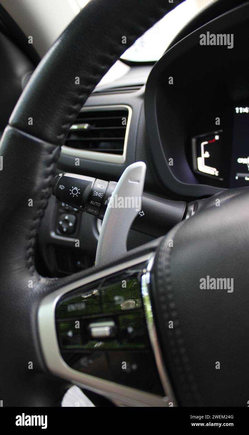 Gear shifter and headlight control lever under steering wheel of modern ...