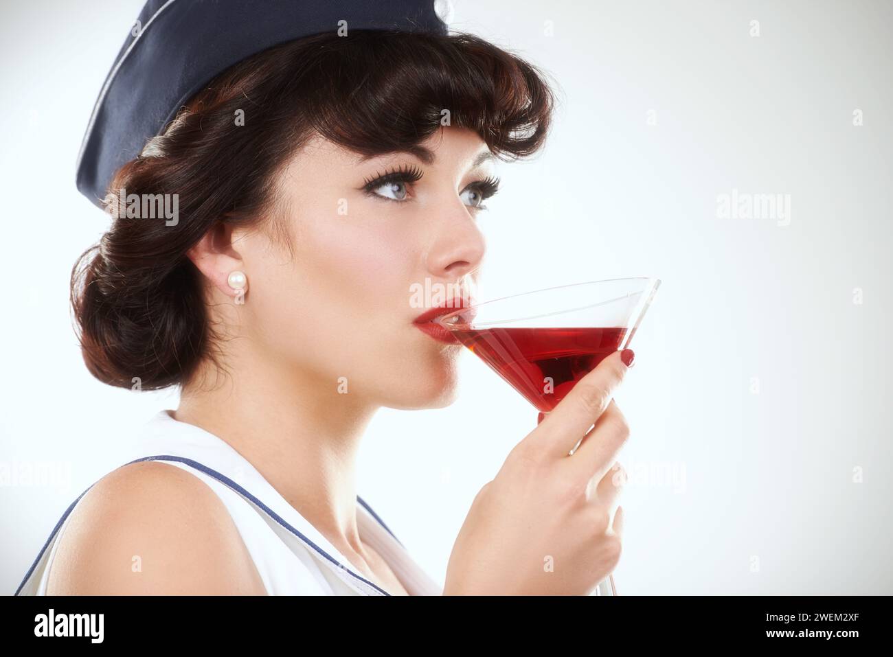 Glass, stewardess and woman drink alcohol in studio isolated on a white ...