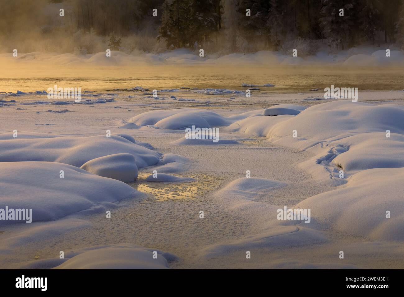 Half-frozen river, where the wind helped create beautiful small hills ...