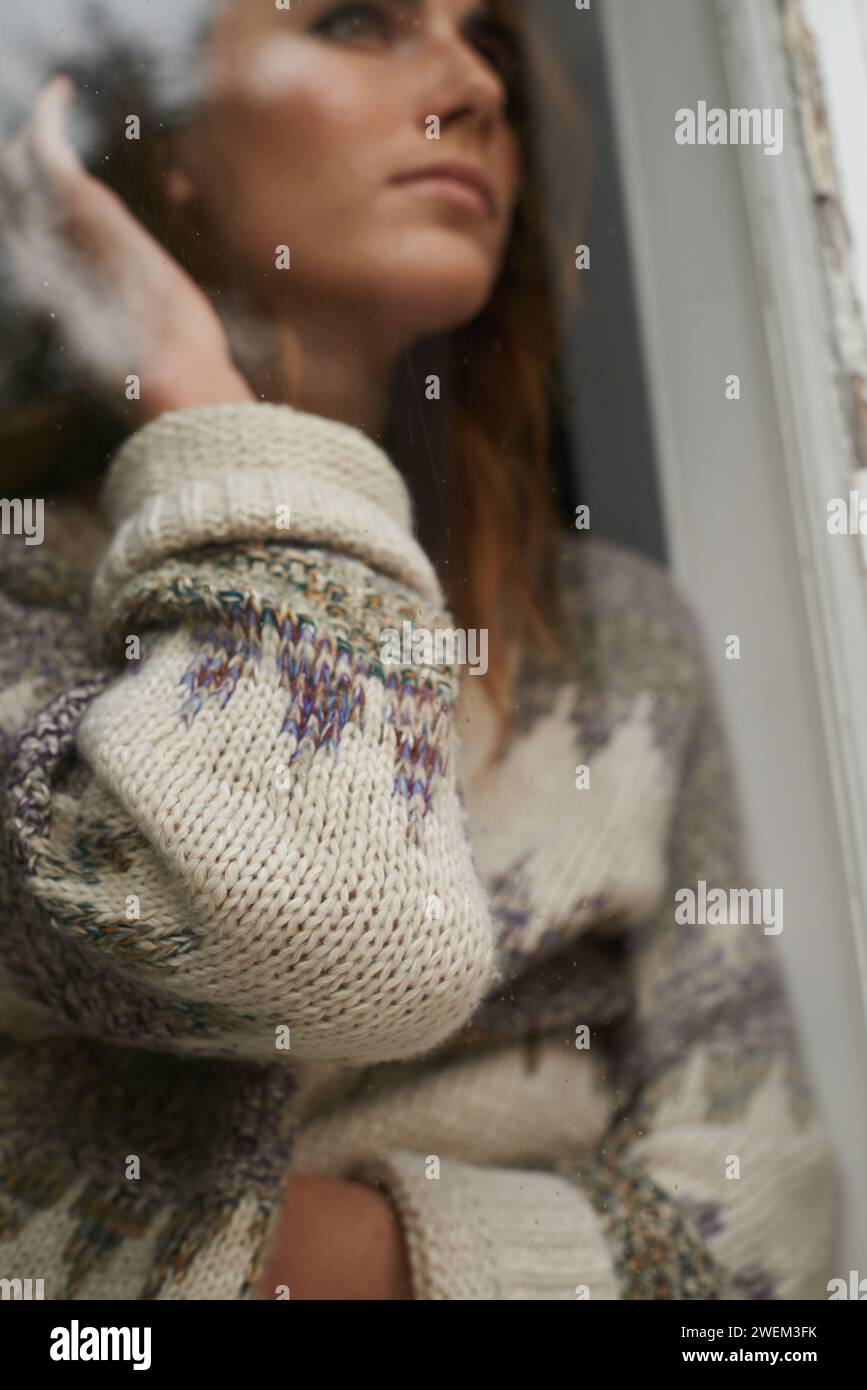 Woman, thinking and ideas by window of home for relax, lonely and ...