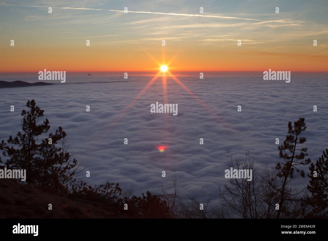 Sun over Clouds in a Heaven like Scene from a top of a Mountain Stock ...