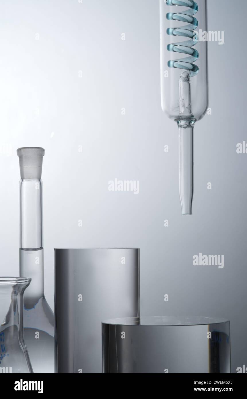Closeup view of lab glassware filled transparent solution and cylinder ...