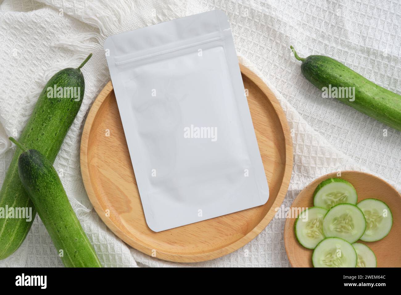Facial sheet mask packaging mockup with cucumber ingredients and fresh ...