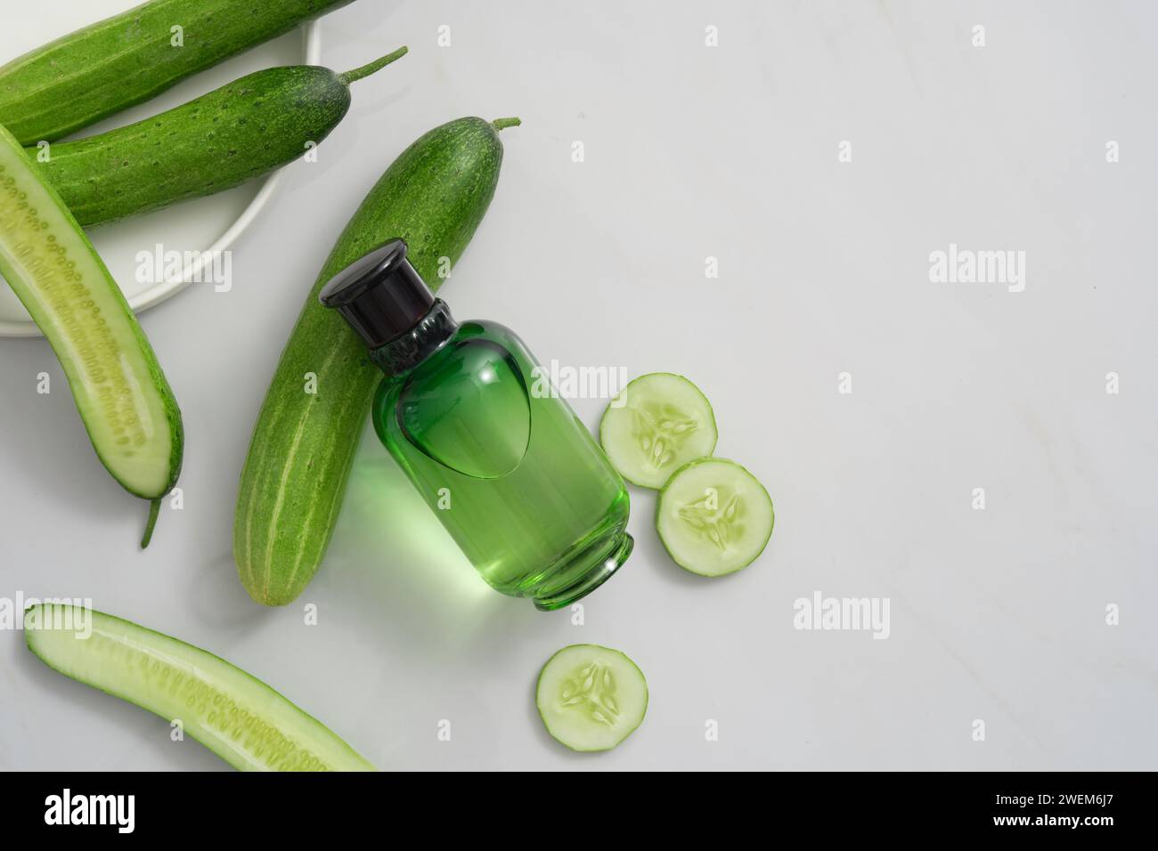 Advertising scene for cucumber extract cosmetics with unlabeled bottle ...