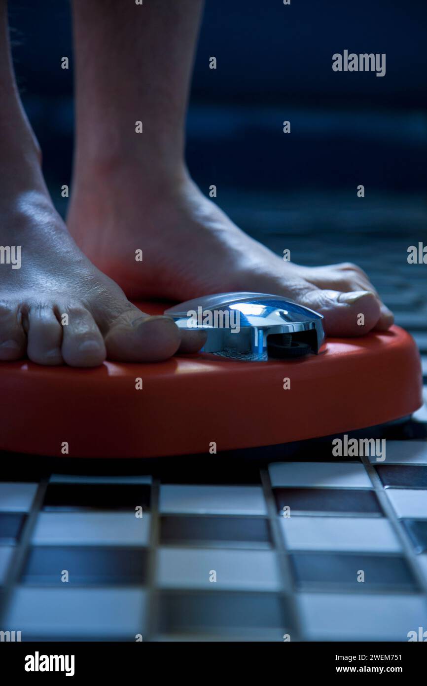 Male feet on scales hi-res stock photography and images - Alamy