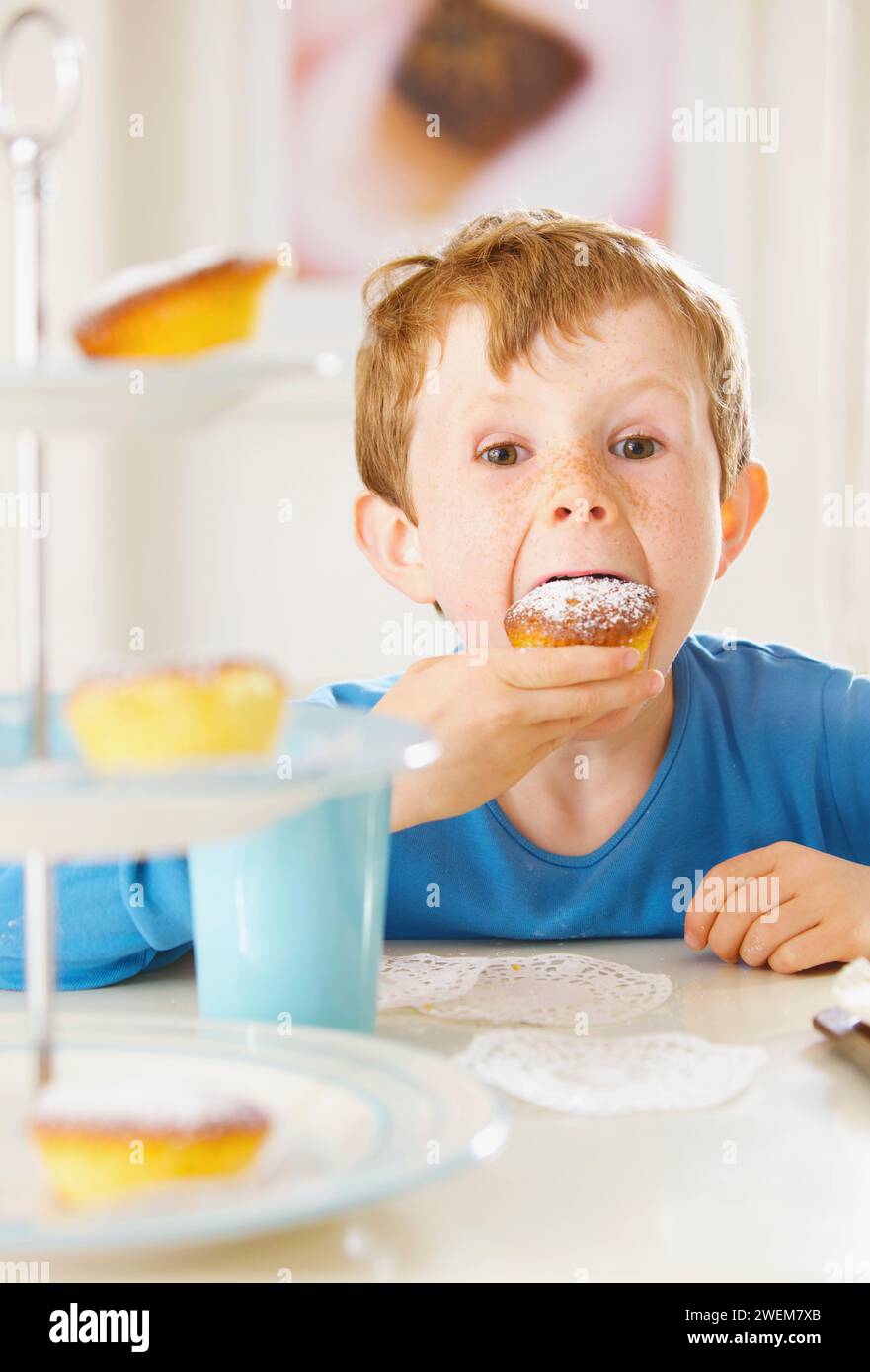 Boy eating a cupcake hi-res stock photography and images - Alamy