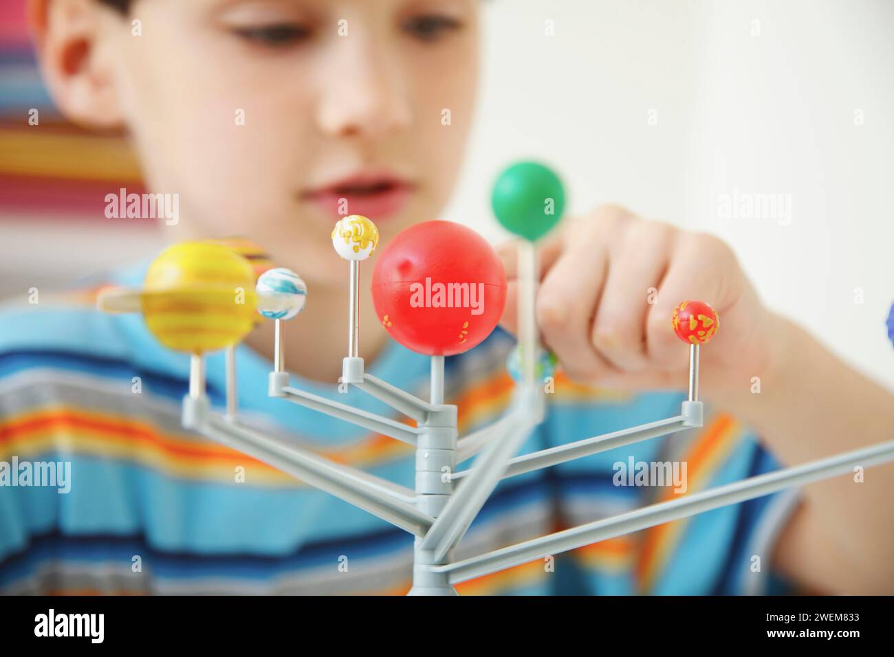 Boy Inspecting Solar System Model Stock Photo - Alamy