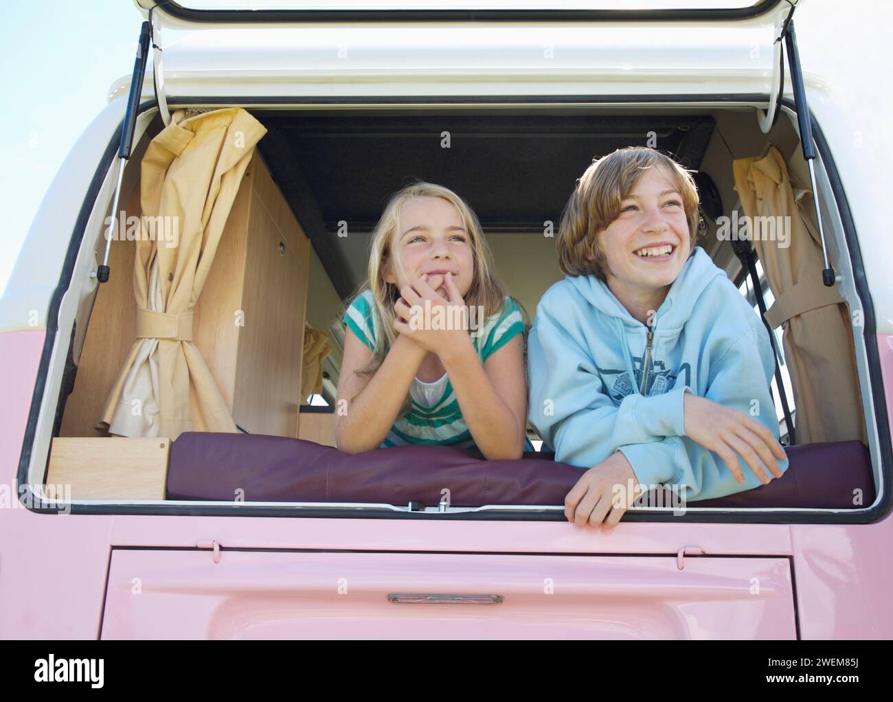 Boy and Girl Looking out of Camper Van Rear Window Stock Photo - Alamy