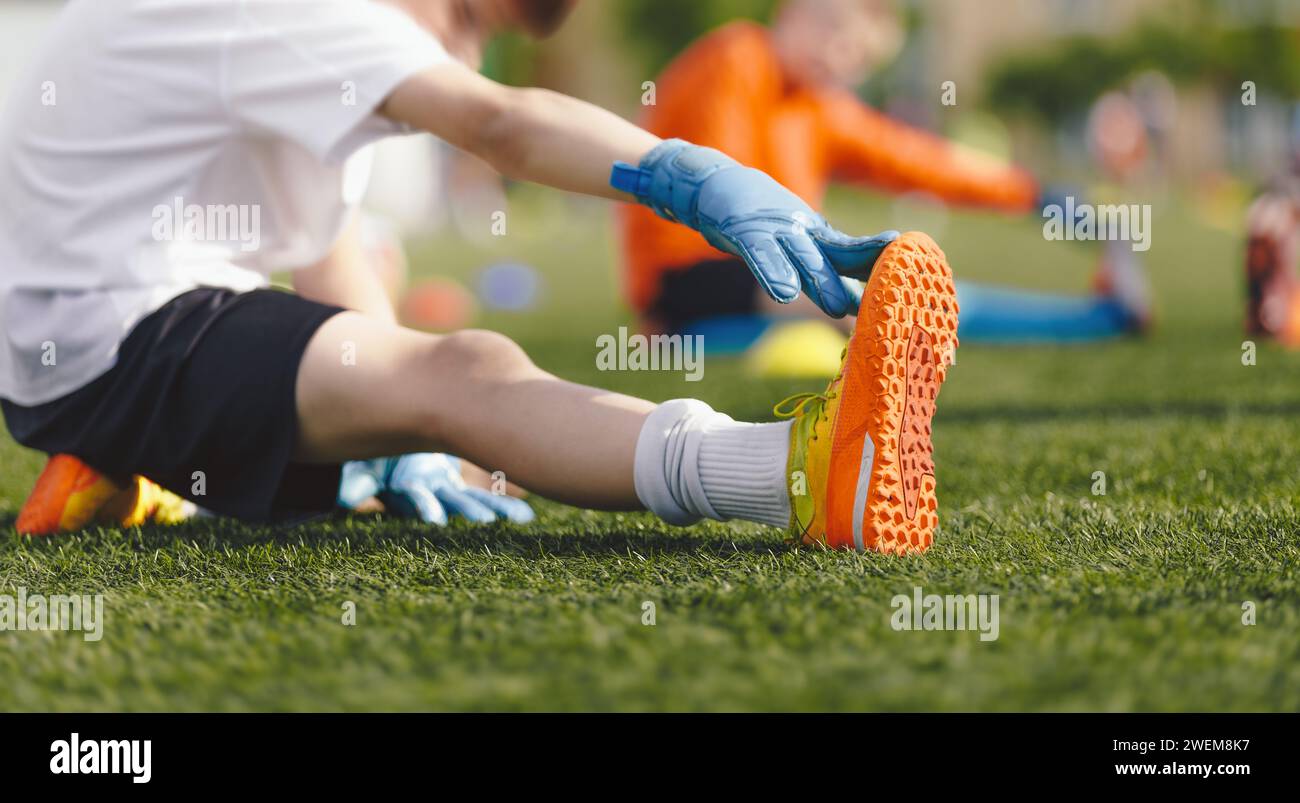 Young Boy Doing Soccer Stretching Exercises. Kids in Football ...