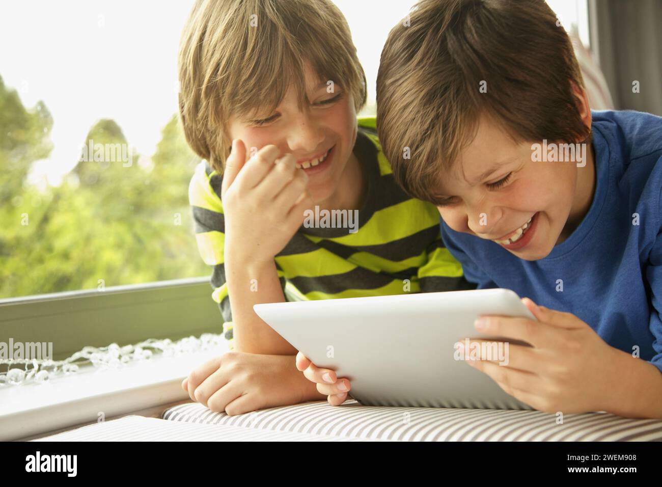 Boys Using Digital Tablet Smiling Stock Photo - Alamy