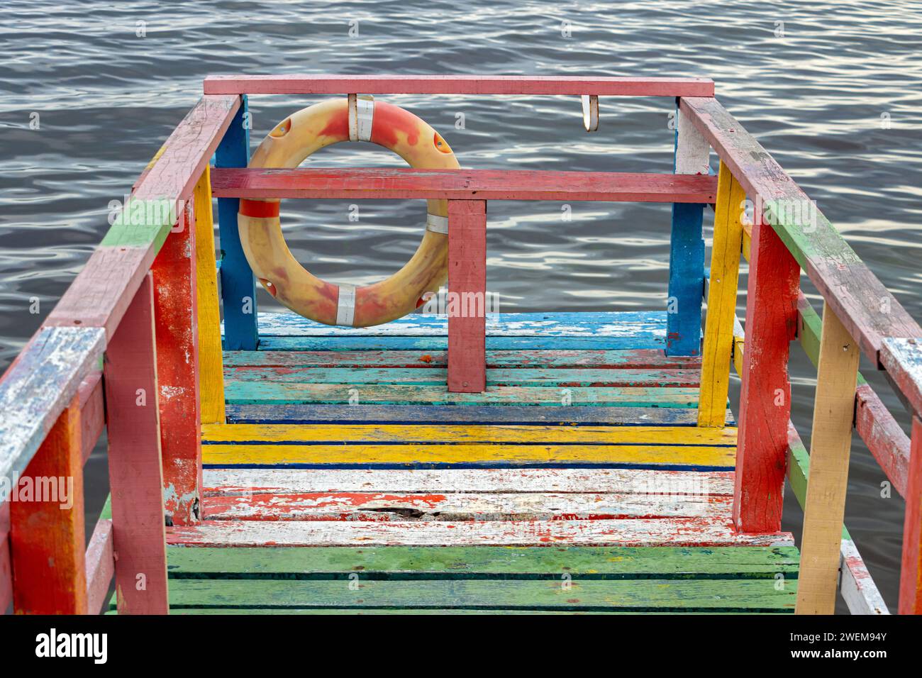 The end of the colorful footbridge over the sea with a lifebuoy Stock ...