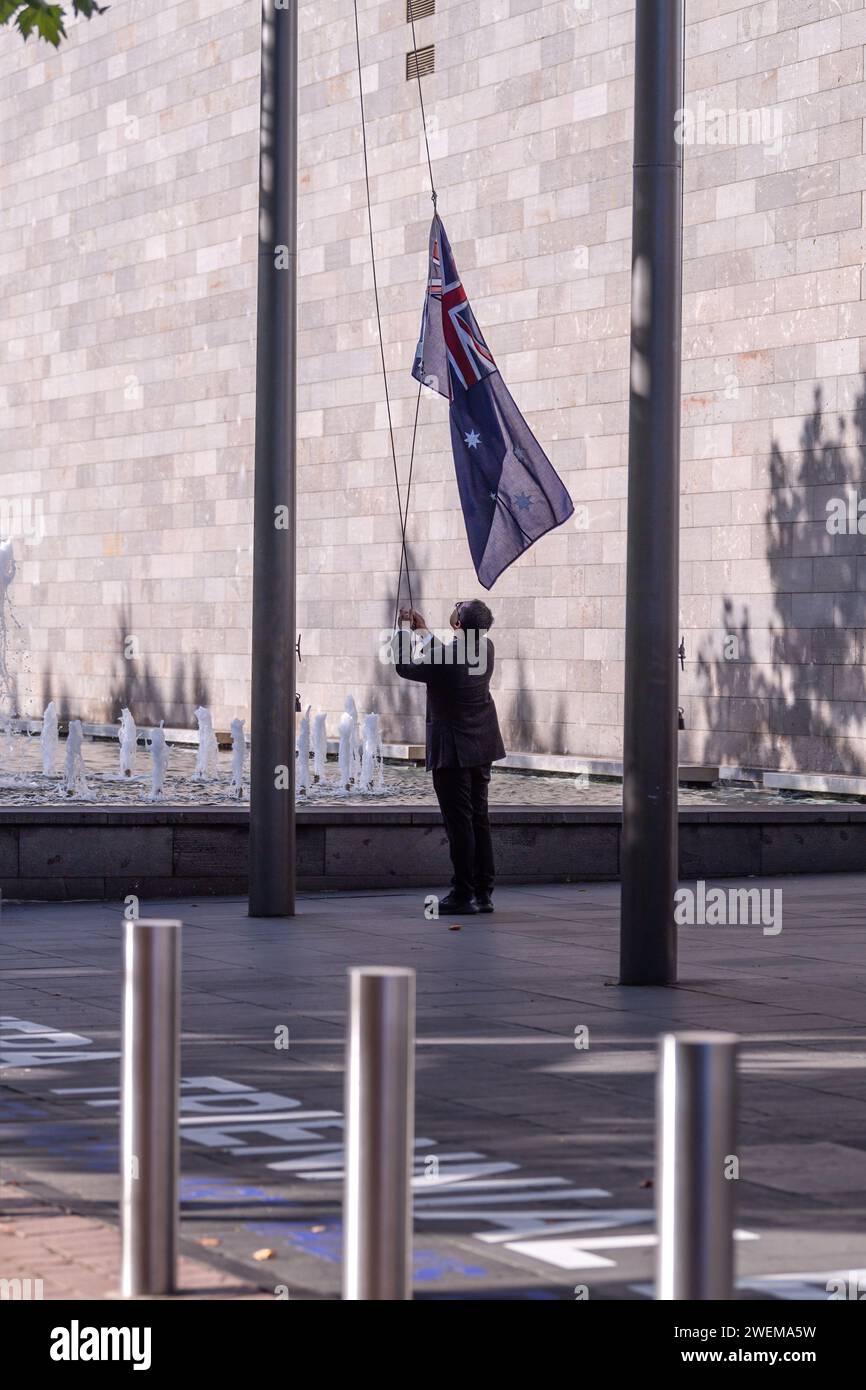 Melbourne, Australia. 26th Jan, 2024. A National Galley employee raises ...
