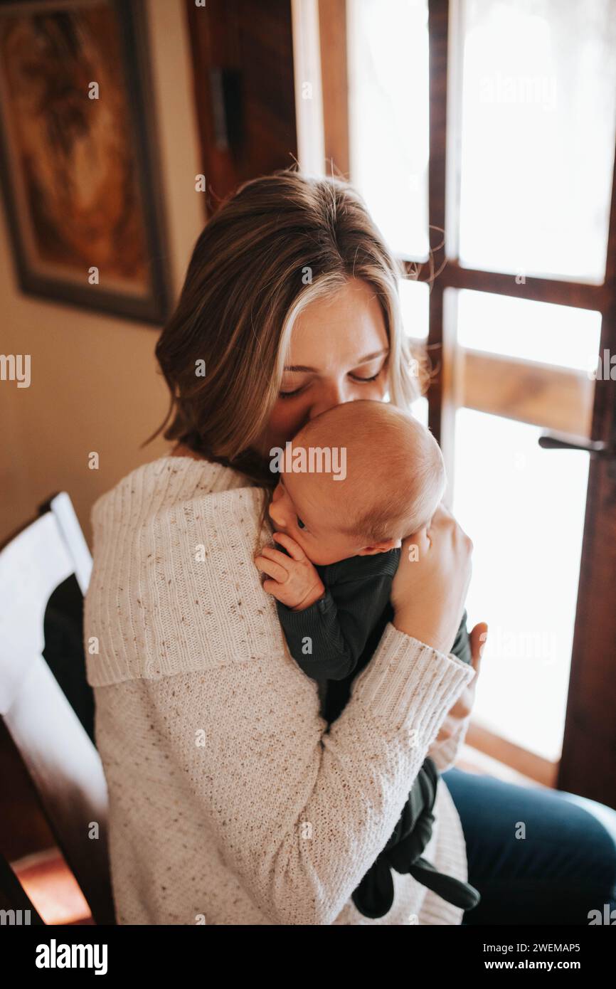 Mom holds newborn son in his new nursery, pure joy Stock Photo - Alamy