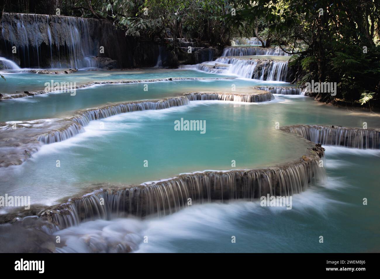 Blue water tropical waterfalls surrounded by lush vegetation Stock ...