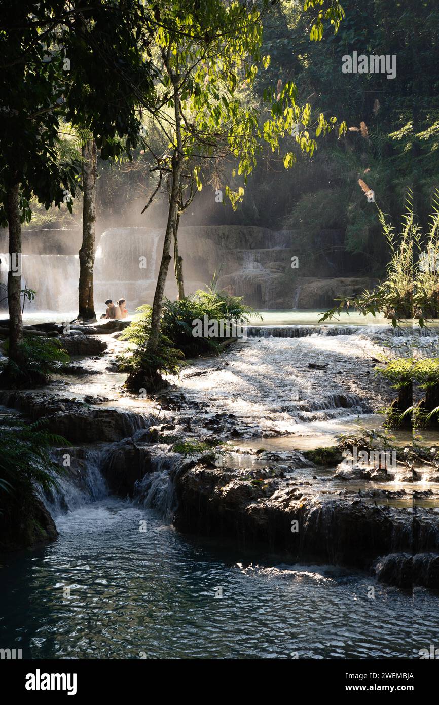 Family swimming in blue waters tropical waterfall during sunset Stock ...
