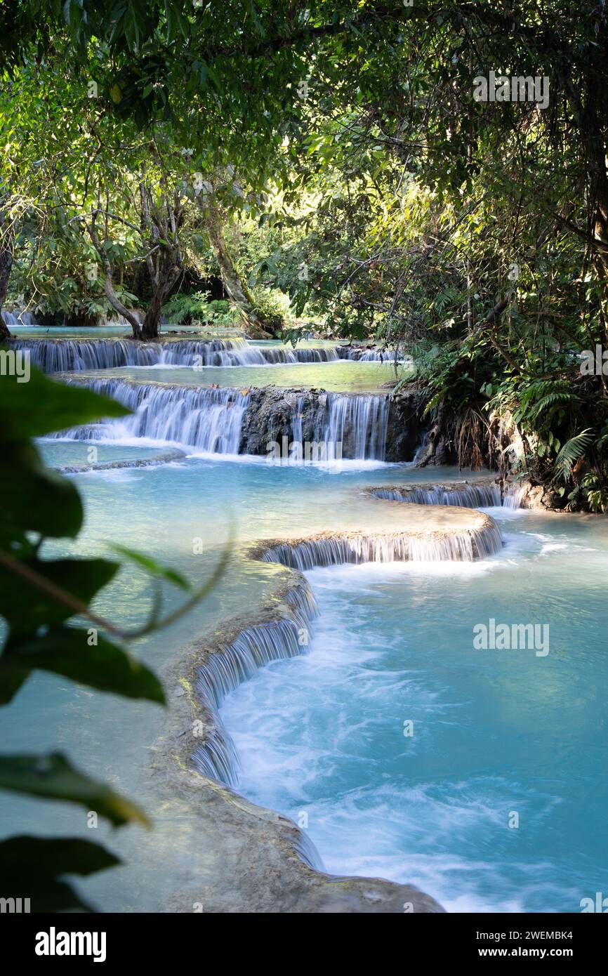 Blue water tropical waterfalls surrounded by lush vegetation Stock ...