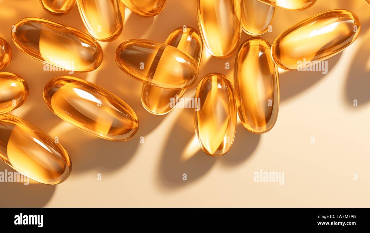 golden omega 3 capsules on peach background color Stock Photo - Alamy