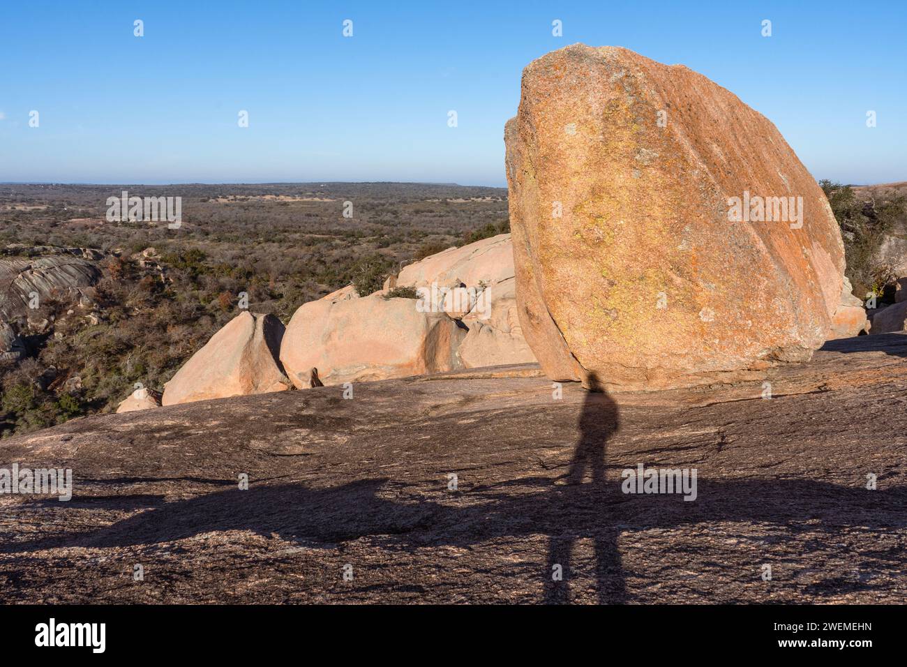 Hiker's shadow from sunlight, near boulders on summit trail in Texas ...